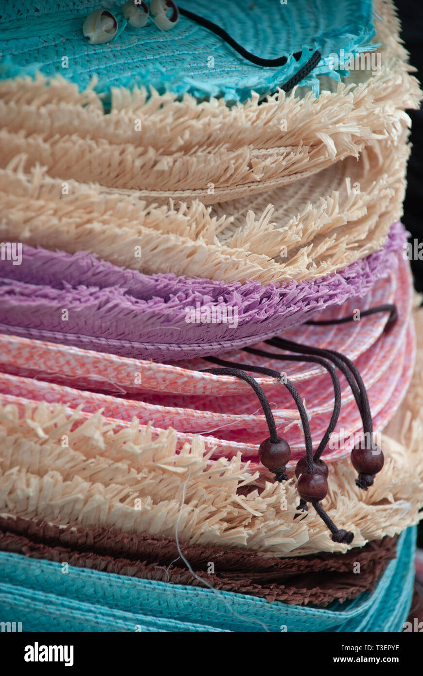 Close-up on a stack of colored straw hats Stock Photo - Alamy