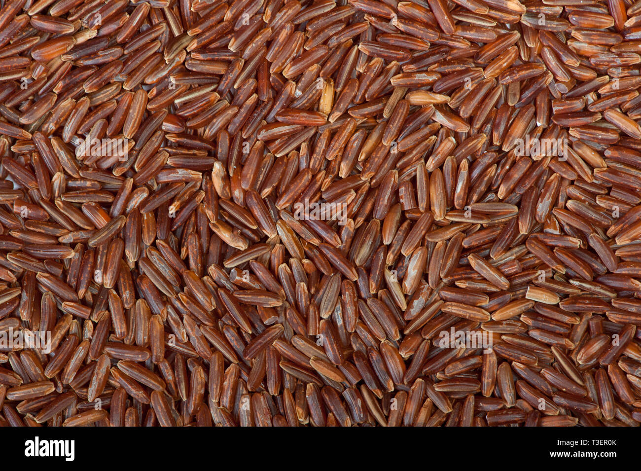 Surface covered with the red rice as a backdrop food texture ...