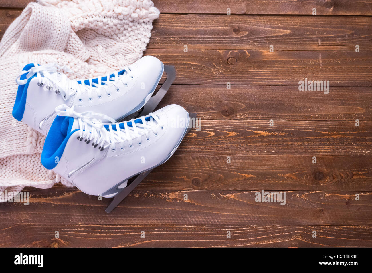 Flat lay. New white figure skates on a wooden boards Stock Photo - Alamy