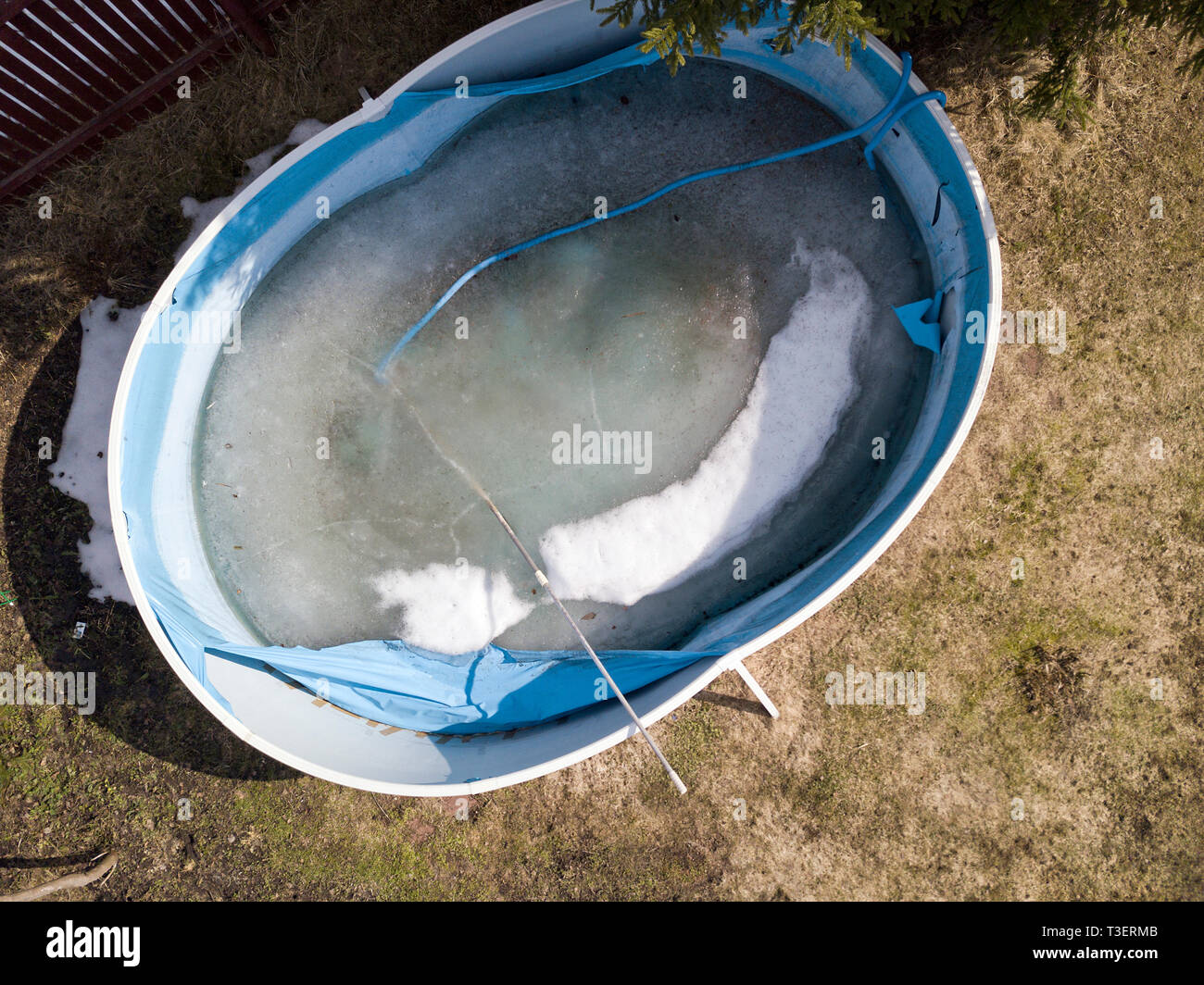 Overhead shot of a lawn and a damaged swimming pool after winter Stock ...