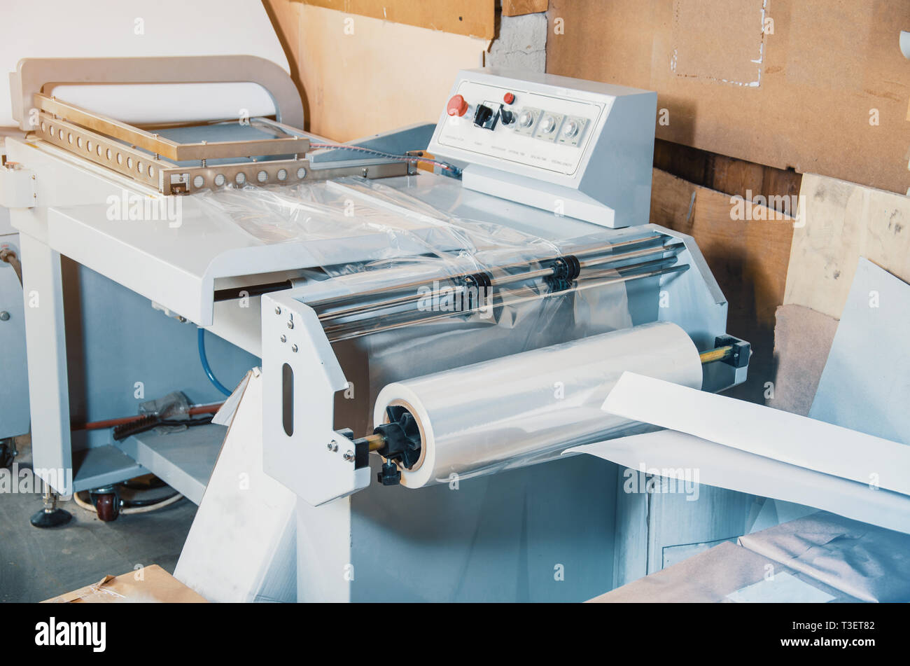 Machine for packing products with the plastic wrap Stock Photo - Alamy