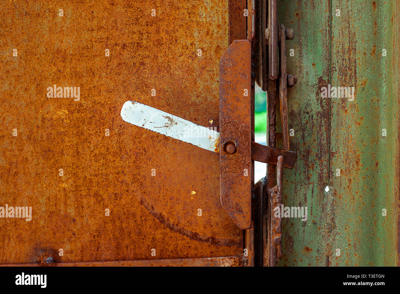 Old secret lock on rusty metal door with cracked and scratch ...
