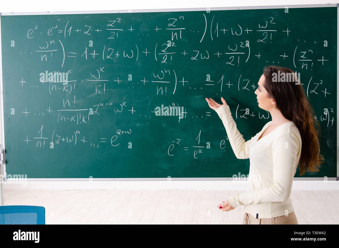 Young female math teacher in front of chalkboard Stock Photo - Alamy