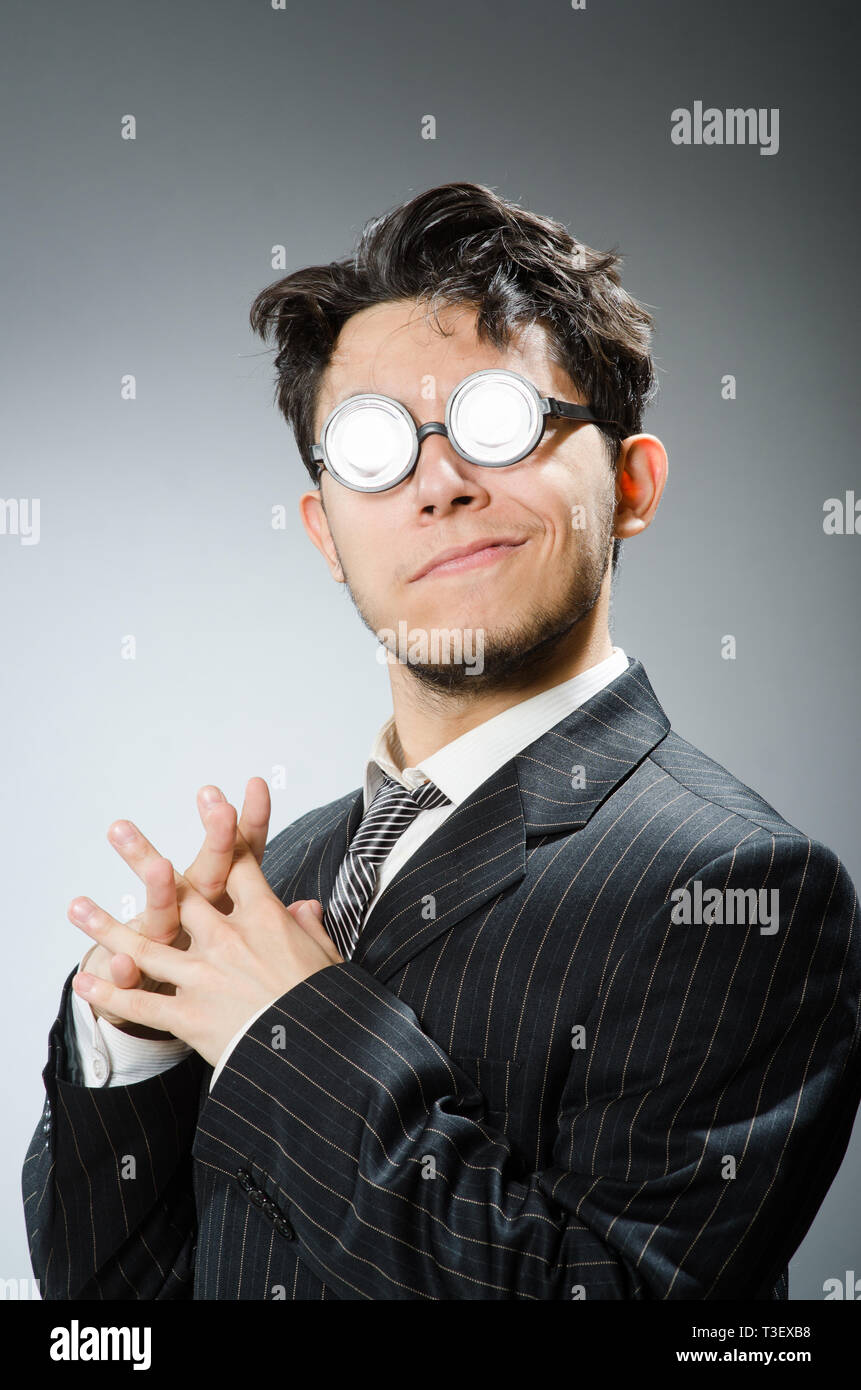 Funny nerd businessman in dark studio Stock Photo - Alamy