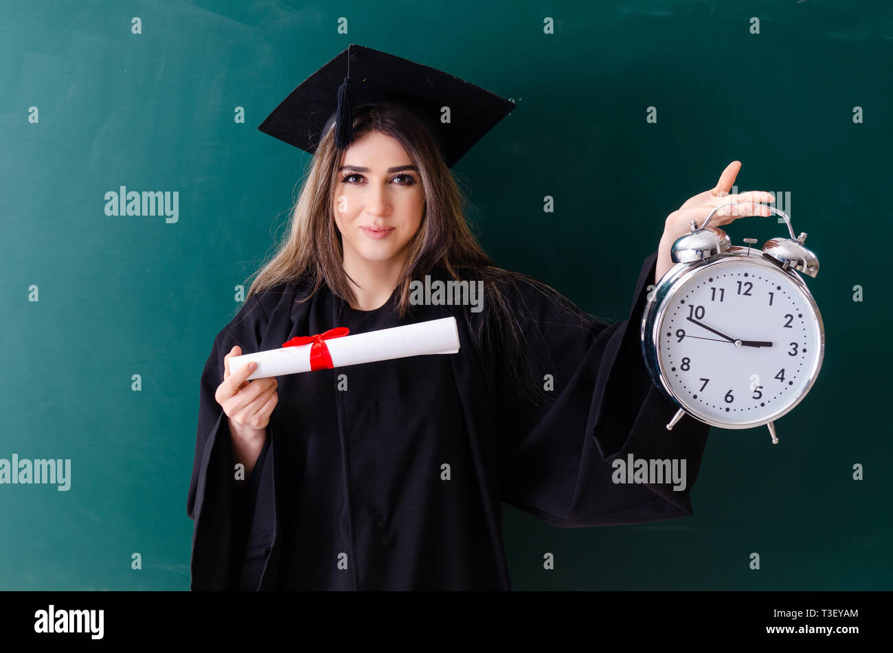 Graduating girl in front of blackboard hi-res stock photography and ...
