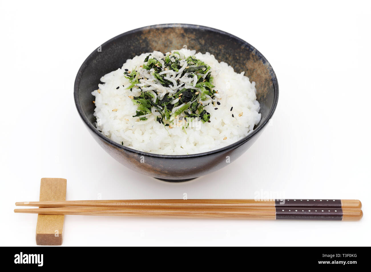 Japanese Shirasu and takana vegetable on cooked white rice on white ...