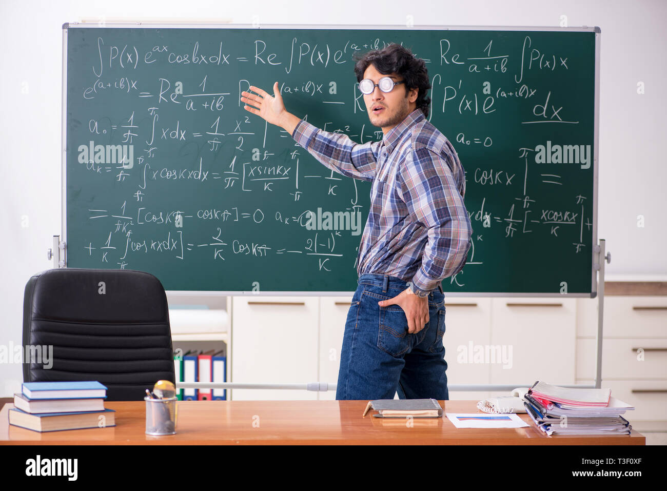 Funny male math teacher in the classroom Stock Photo - Alamy