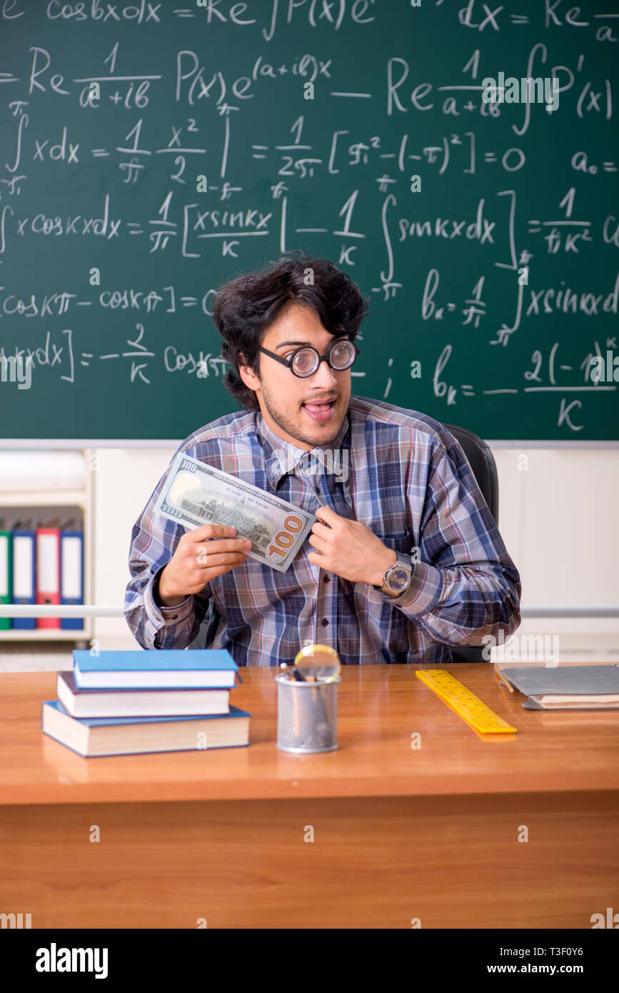 Funny male math teacher in the classroom Stock Photo - Alamy