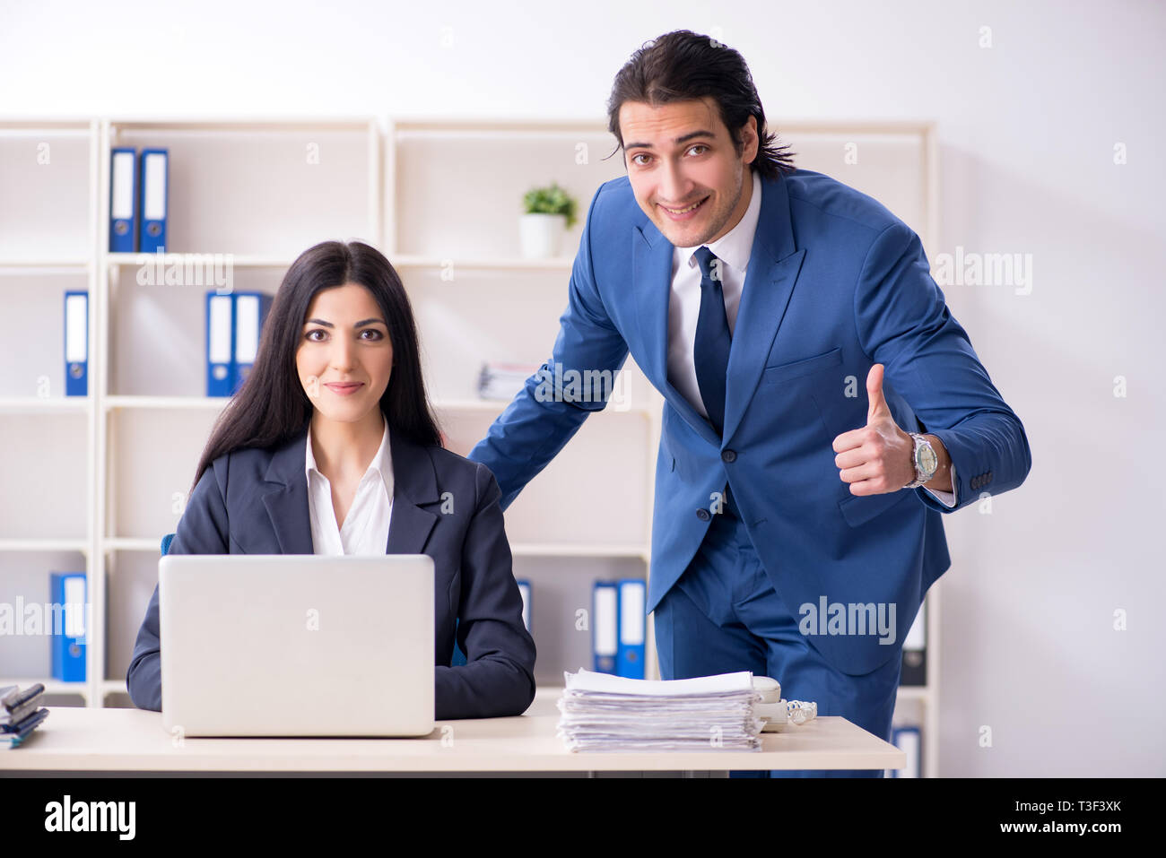 Two employees working in the office Stock Photo - Alamy