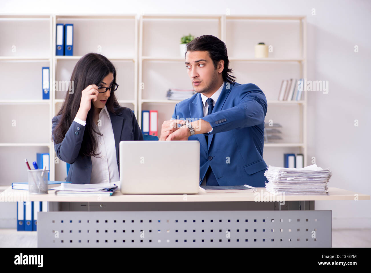 Busy woman checking watch and working hi-res stock photography and ...