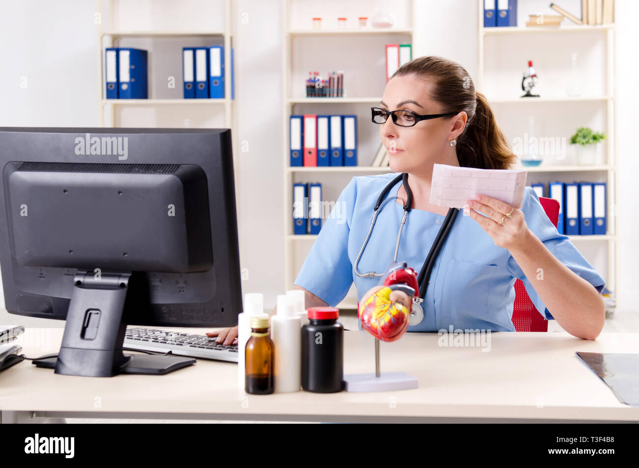 Female doctor cardiologist working in the clinic Stock Photo - Alamy