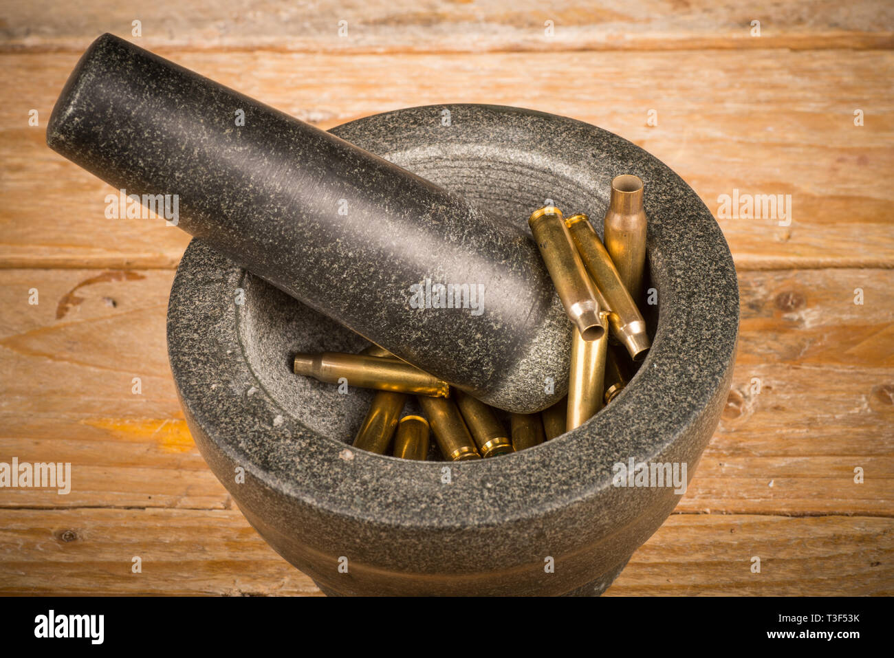 Mortar and pestle with bullets inside ready to be crushed, an anti war ...