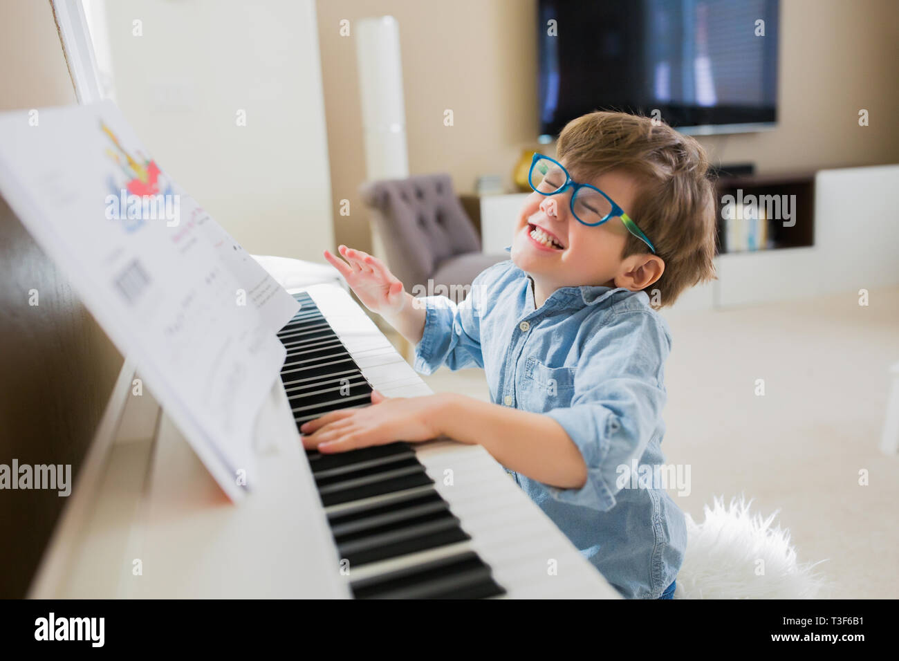 Toddler boy is having so much fun playing the piano Stock Photo - Alamy