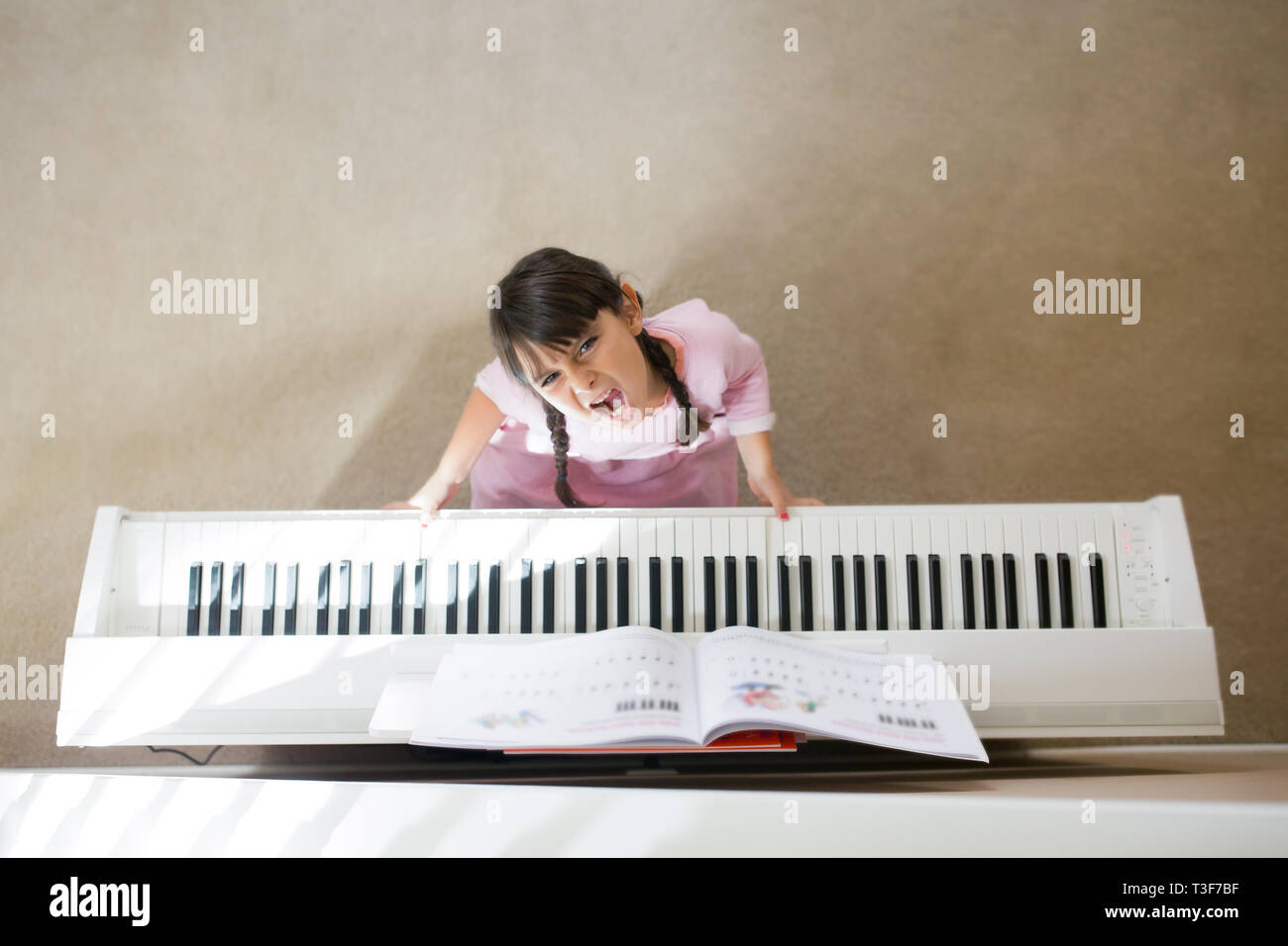 Unhappy girl has an angry facial expression. She is not happy to be ...
