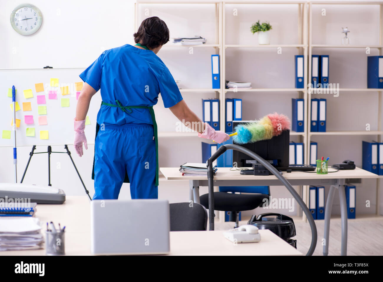 Male handsome professional cleaner working in the office Stock Photo ...