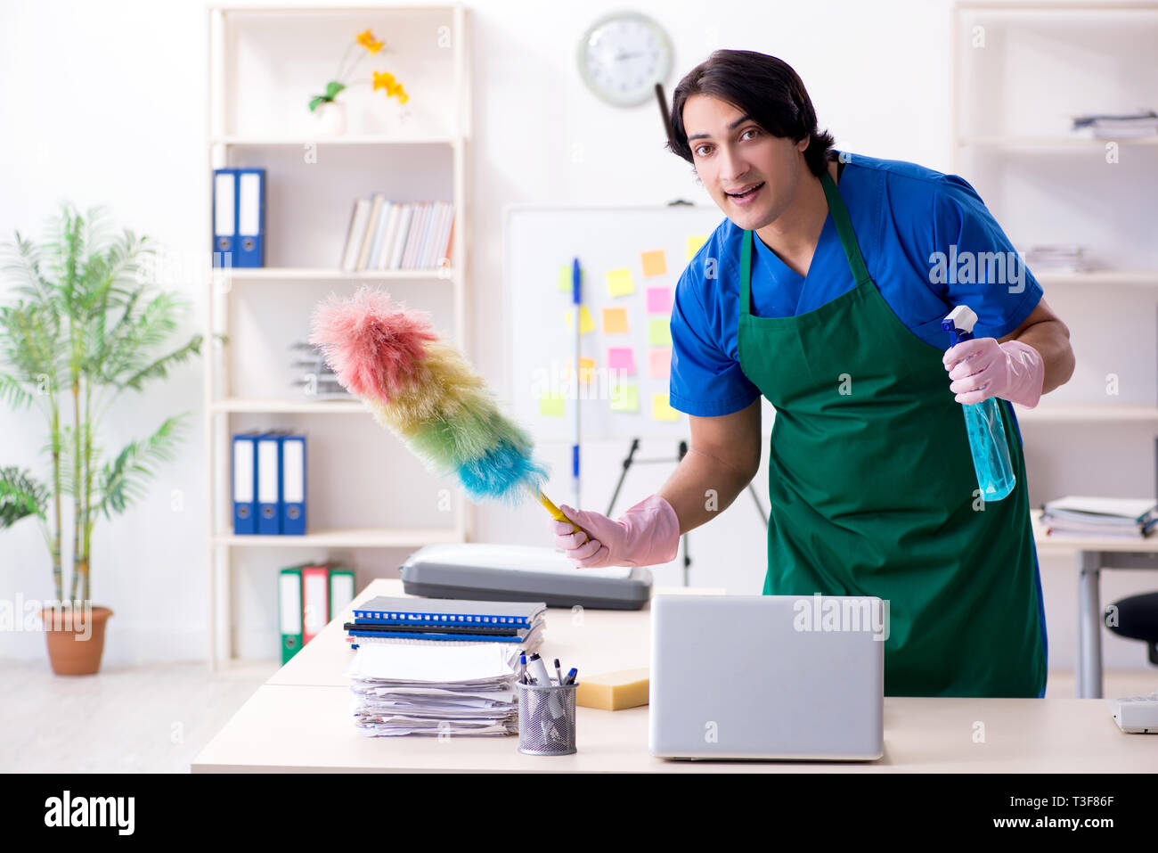 Male handsome professional cleaner working in the office Stock Photo ...