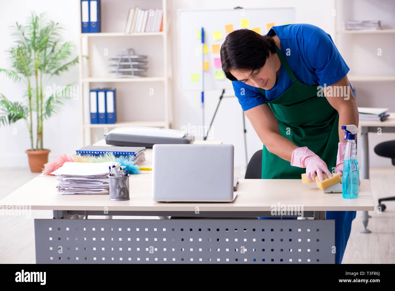 Male handsome professional cleaner working in the office Stock Photo ...
