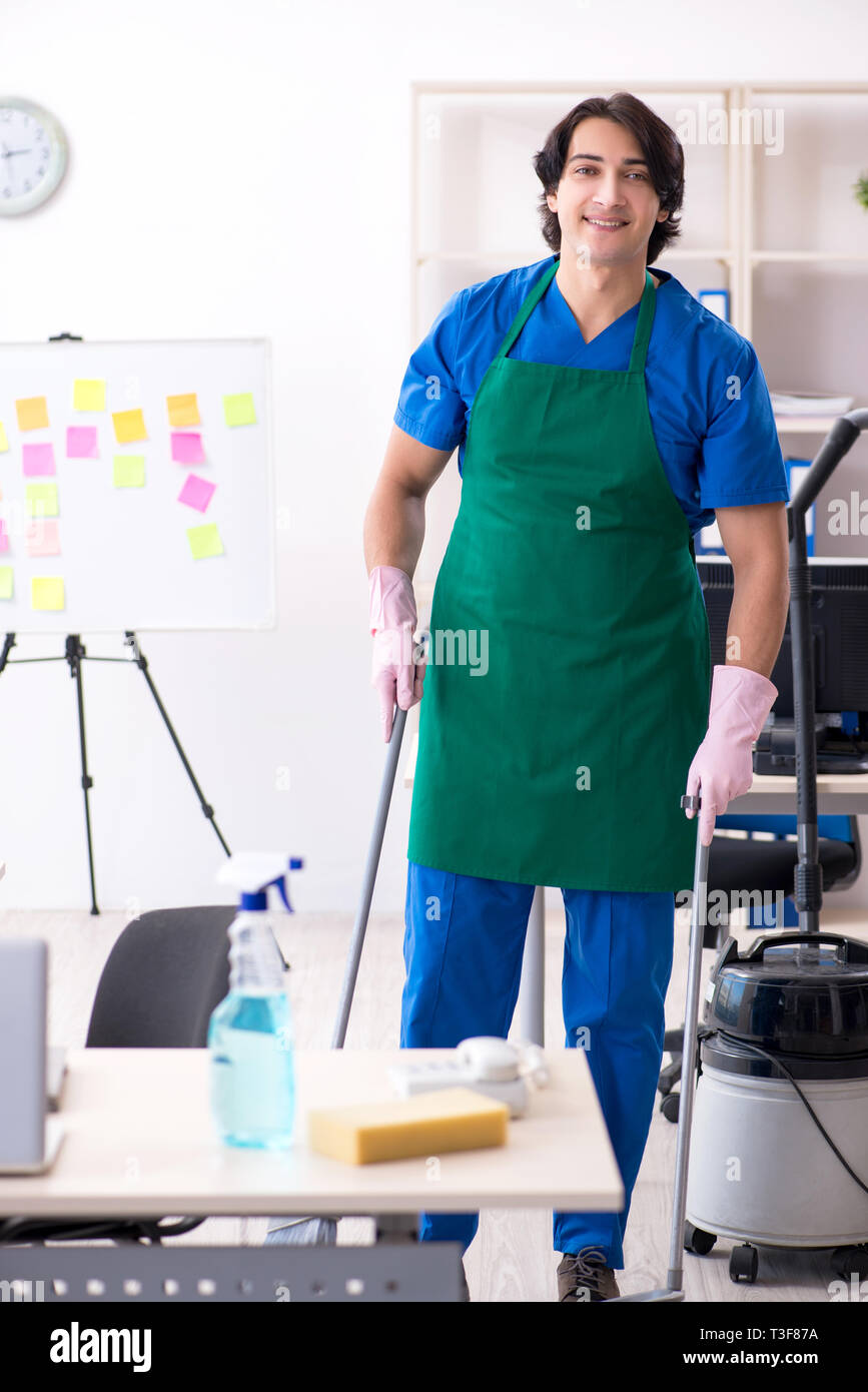 Male handsome professional cleaner working in the office Stock Photo ...