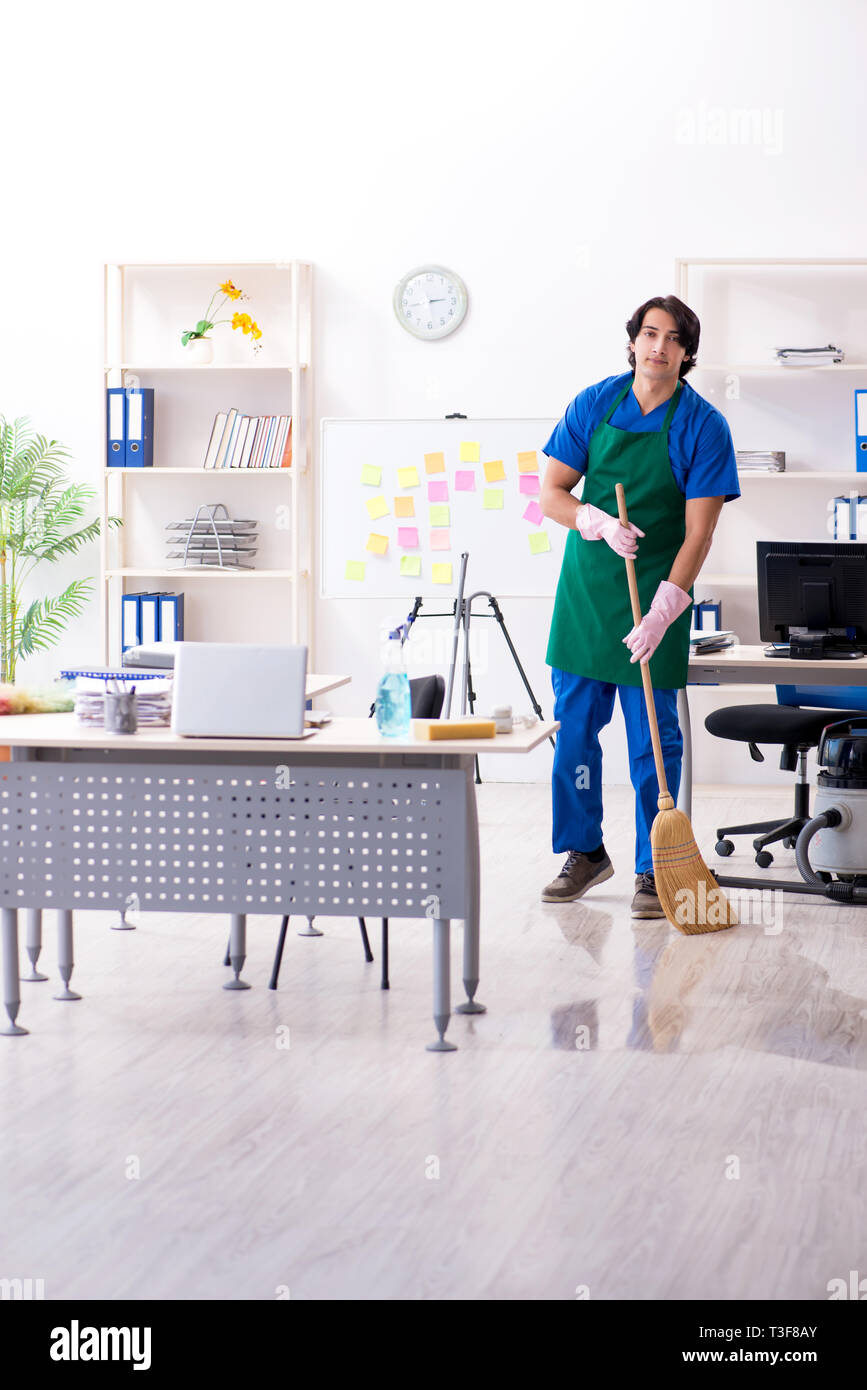 Male handsome professional cleaner working in the office Stock Photo ...