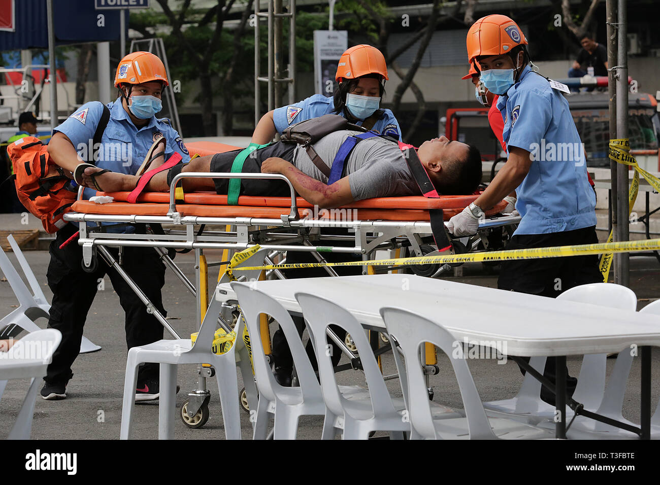 Quezon City. 9th Apr, 2019. Rescue workers carry a mock bombing victim ...