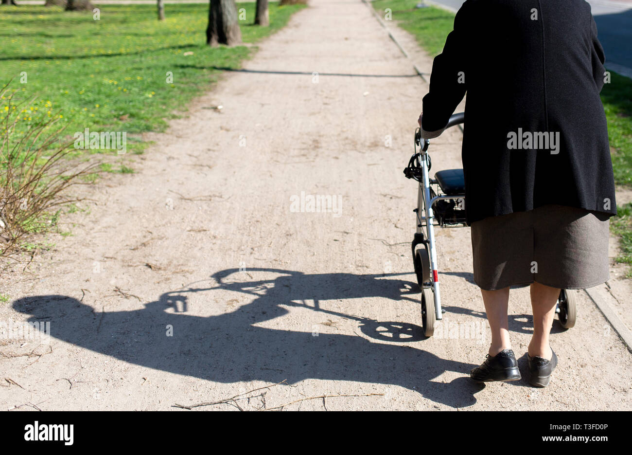 Neuruppin, Germany. 07th Apr, 2019. An elderly woman with a rollator ...