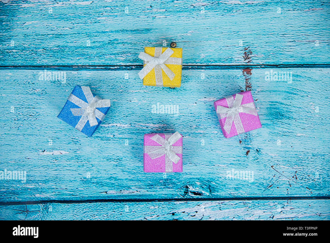 Coloured Small Boxes with Ribbons on Wooden Blue Background Stock Photo ...