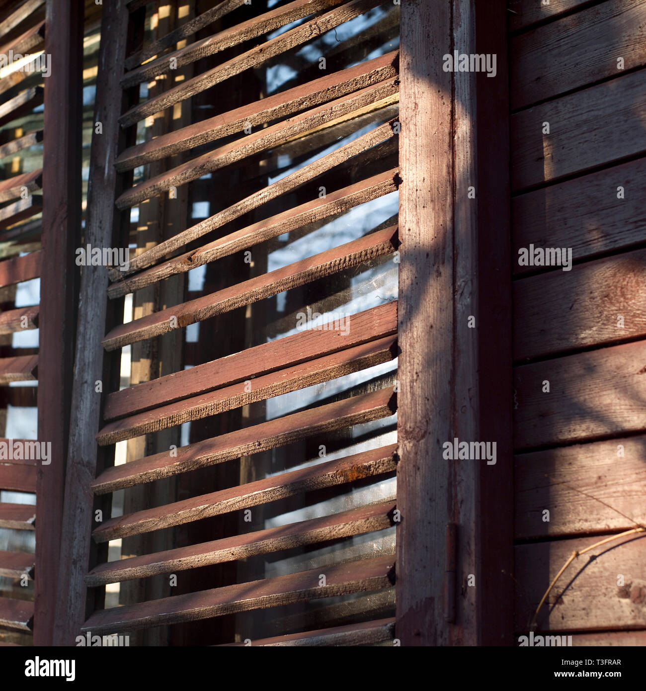 Damaged wooden blinds on a window of abandoned house Stock Photo - Alamy