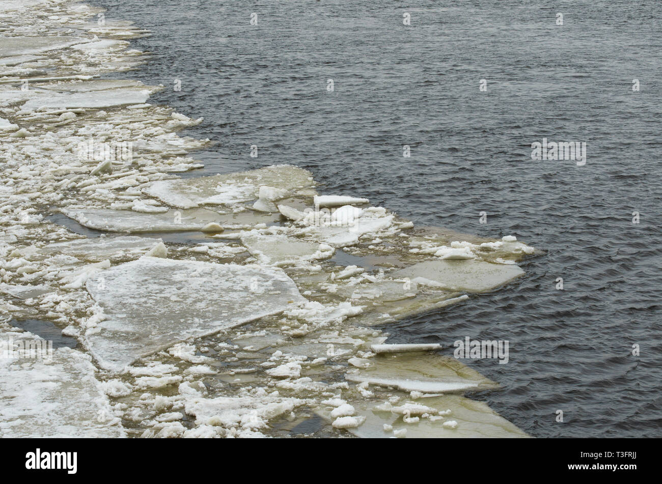 Edge of the ice field and the sludge on the brownish river Stock Photo ...