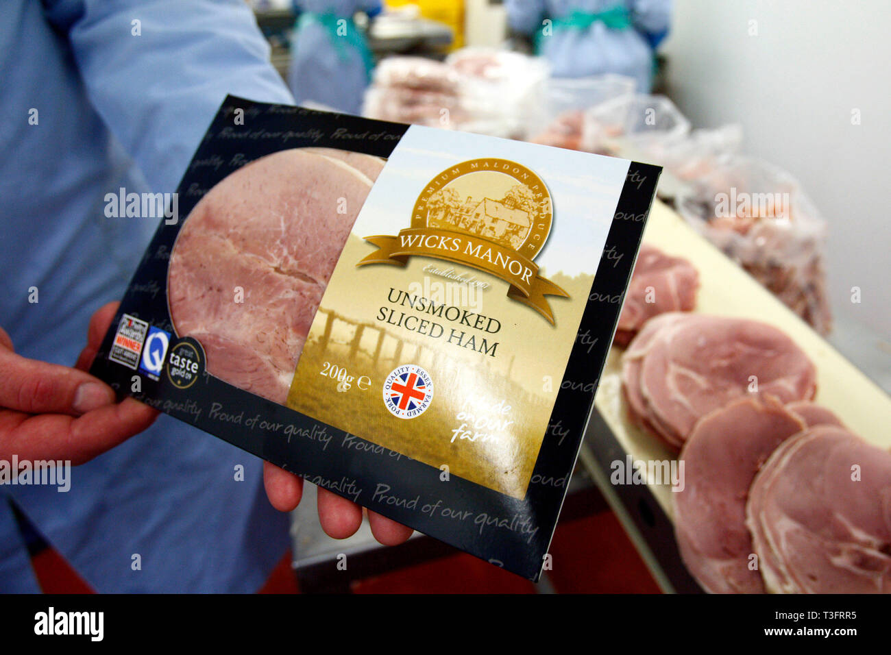 Butchers at work on unsmoked sliced ham. Wicks Manor pig farm ...