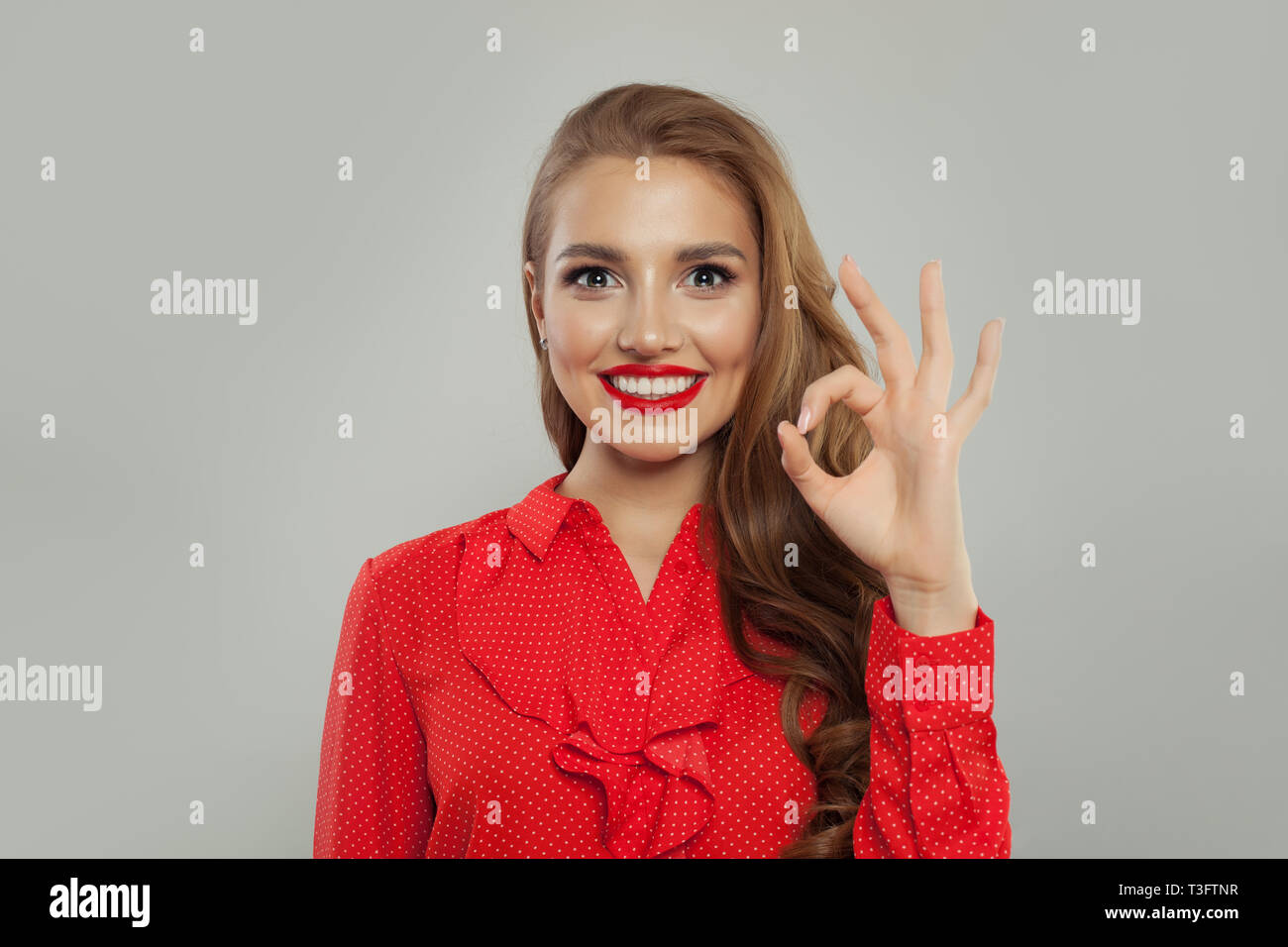 Pretty model woman showing ok sign Stock Photo - Alamy