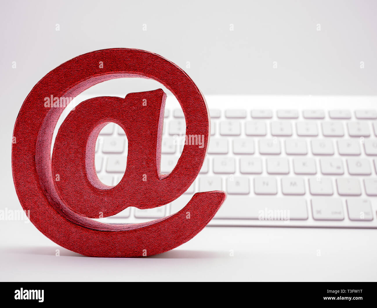 Red email symbol in front of computer keyboard Stock Photo - Alamy