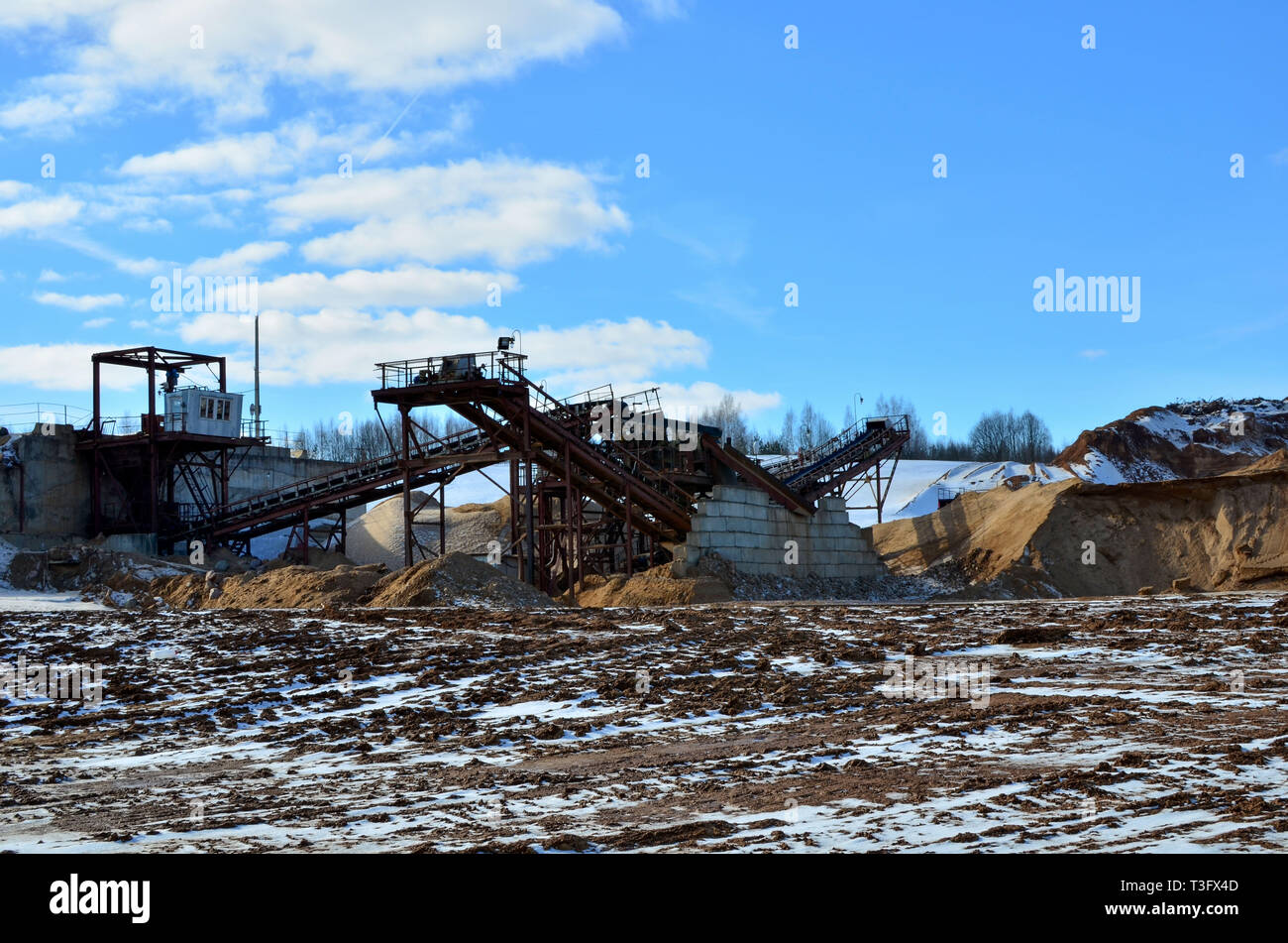 Crusher plant on the background of the blue sky with clouds. Quarry for ...