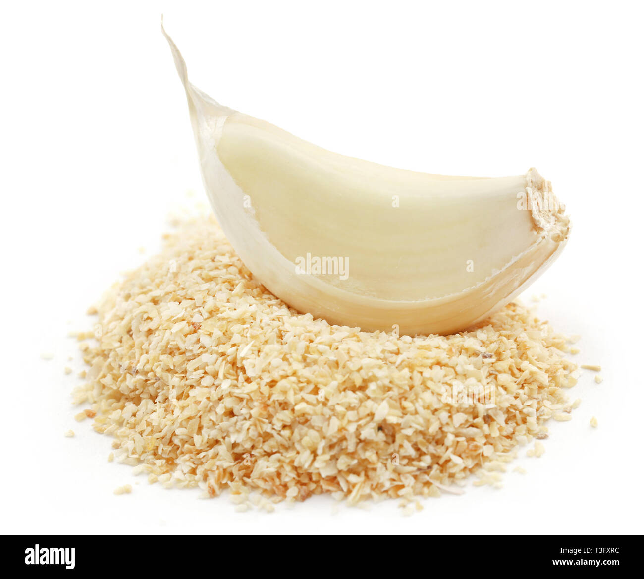 Garlic powder with piece of garlic over white background Stock Photo ...