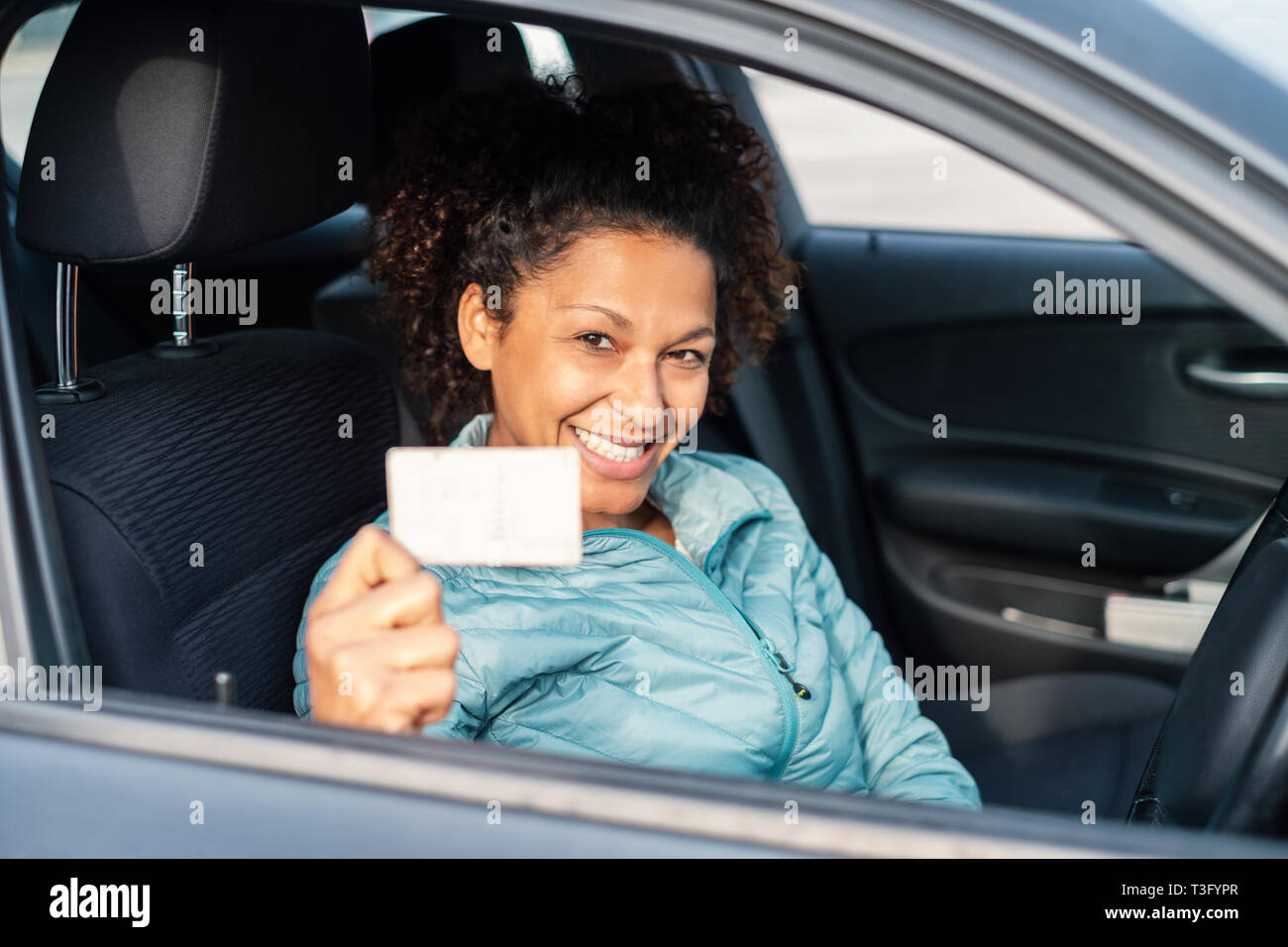 Black car driver woman smiling showing new driver's license Stock Photo ...
