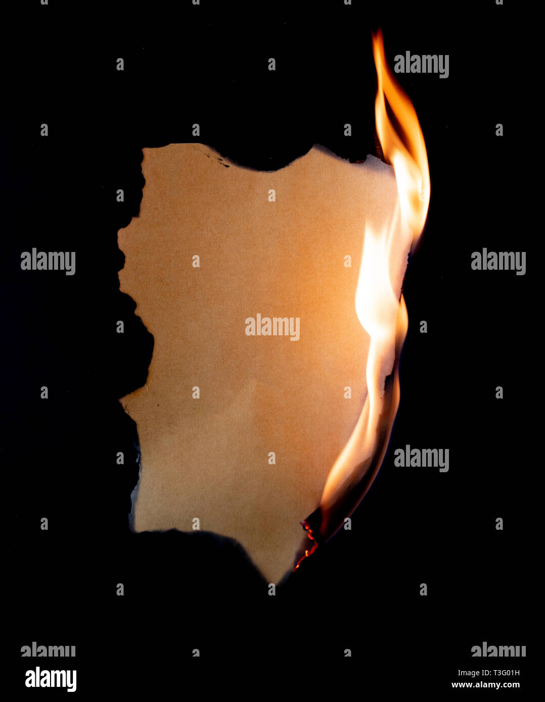 burning piece of paper on black background Stock Photo - Alamy