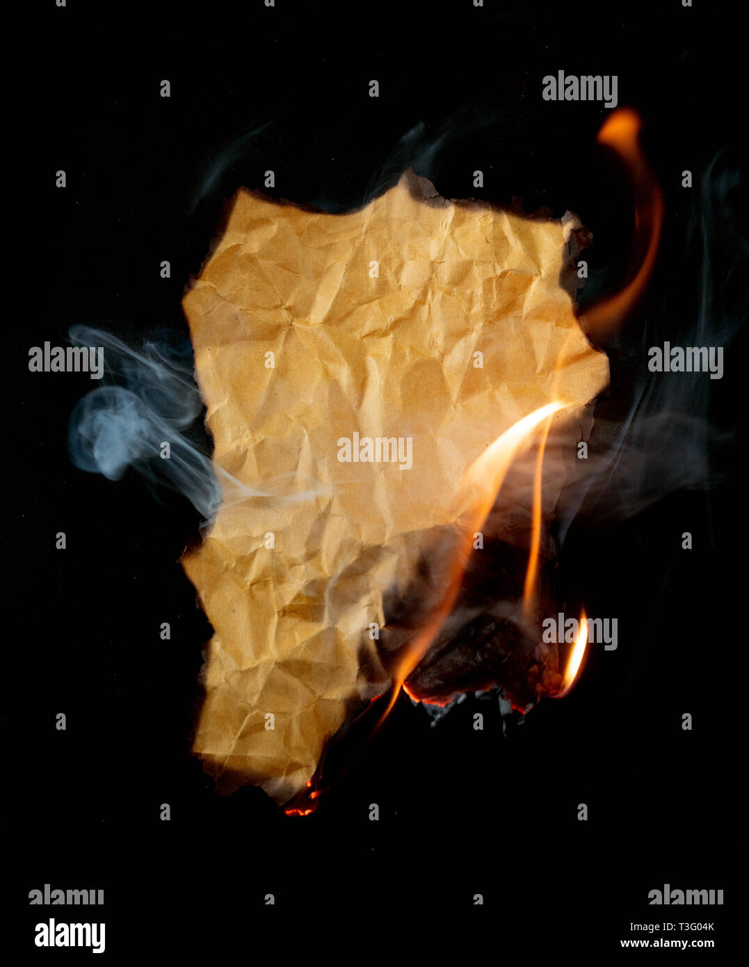 burning piece of crumpled paper on black background Stock Photo - Alamy