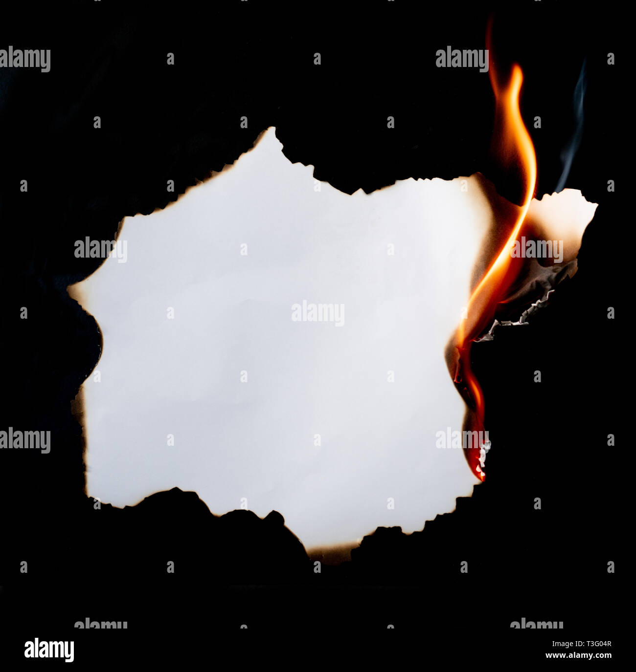 burning piece of paper on black background Stock Photo - Alamy
