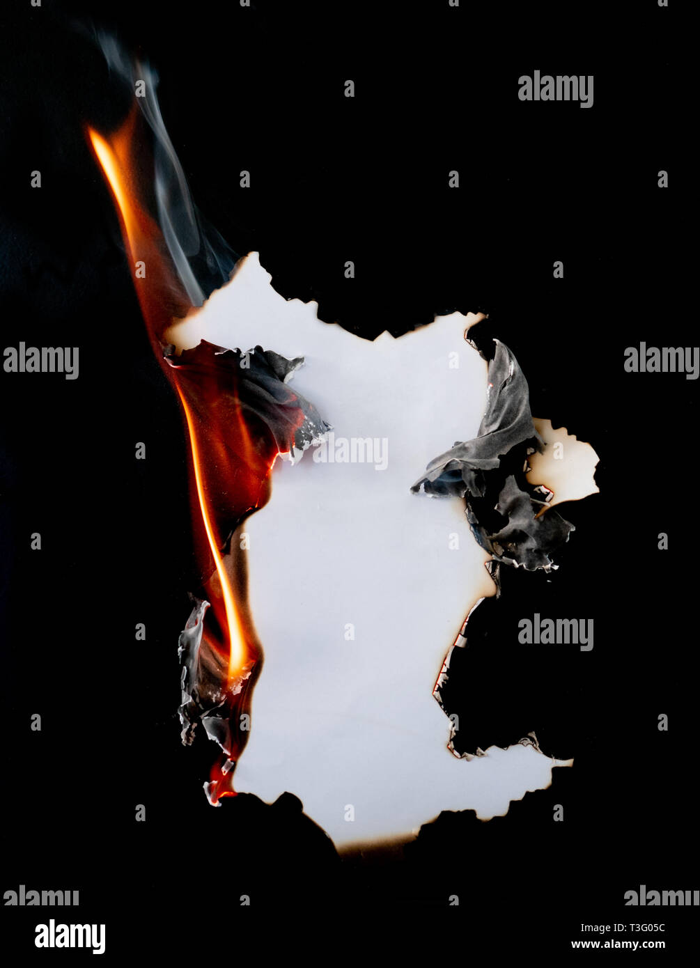 burning piece of paper on black background Stock Photo - Alamy