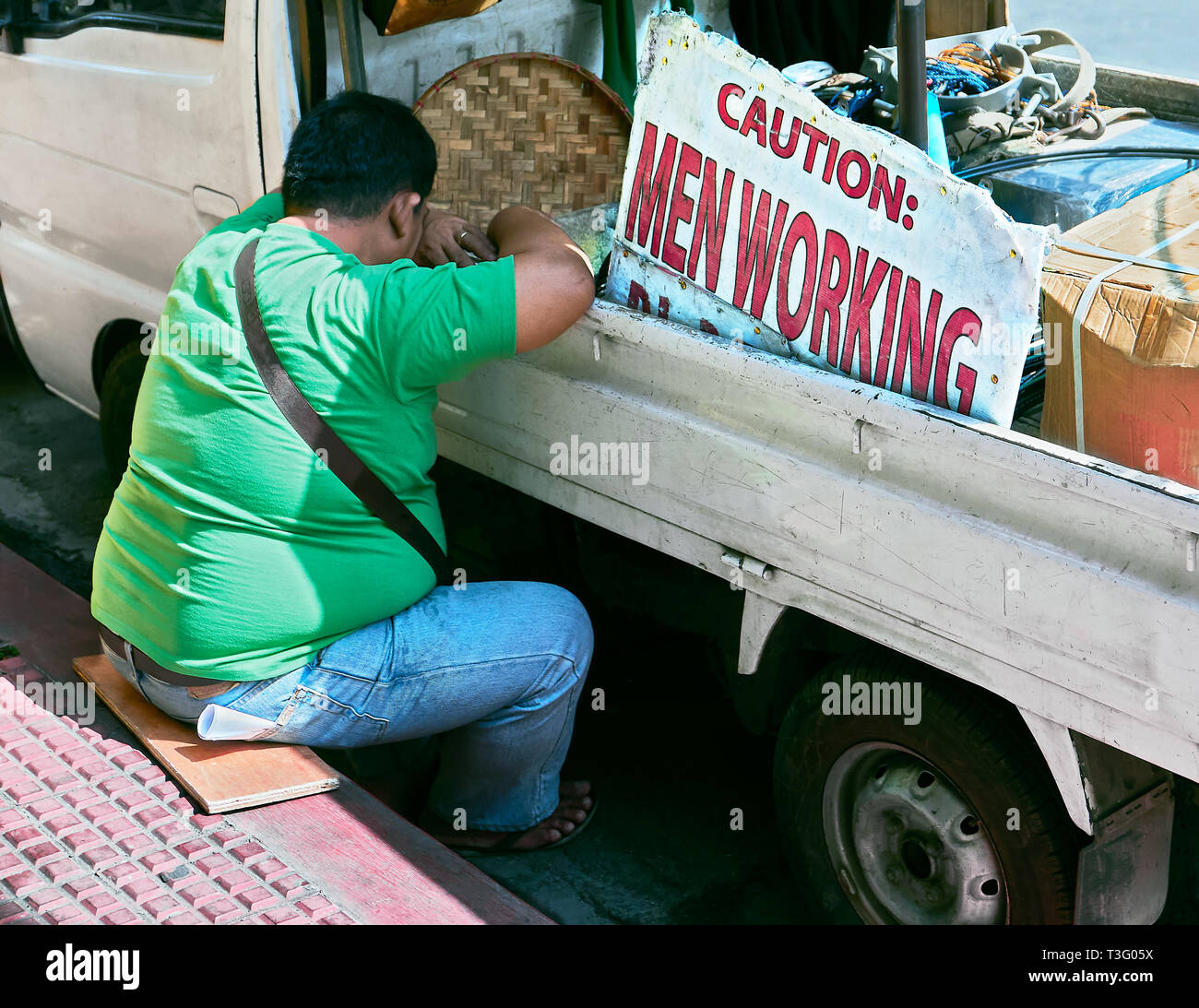 Manila, Philippines: Overweight man sitting on the floor leaning ...