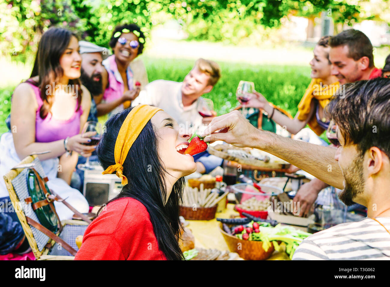 Happy friends making a picnic in the garden outdoor - Young trendy ...