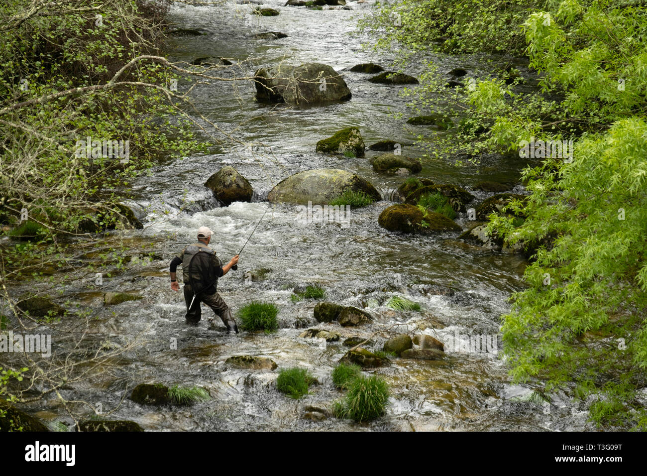 Overhead view of a fisherman wearing waders while fishing inside a ...