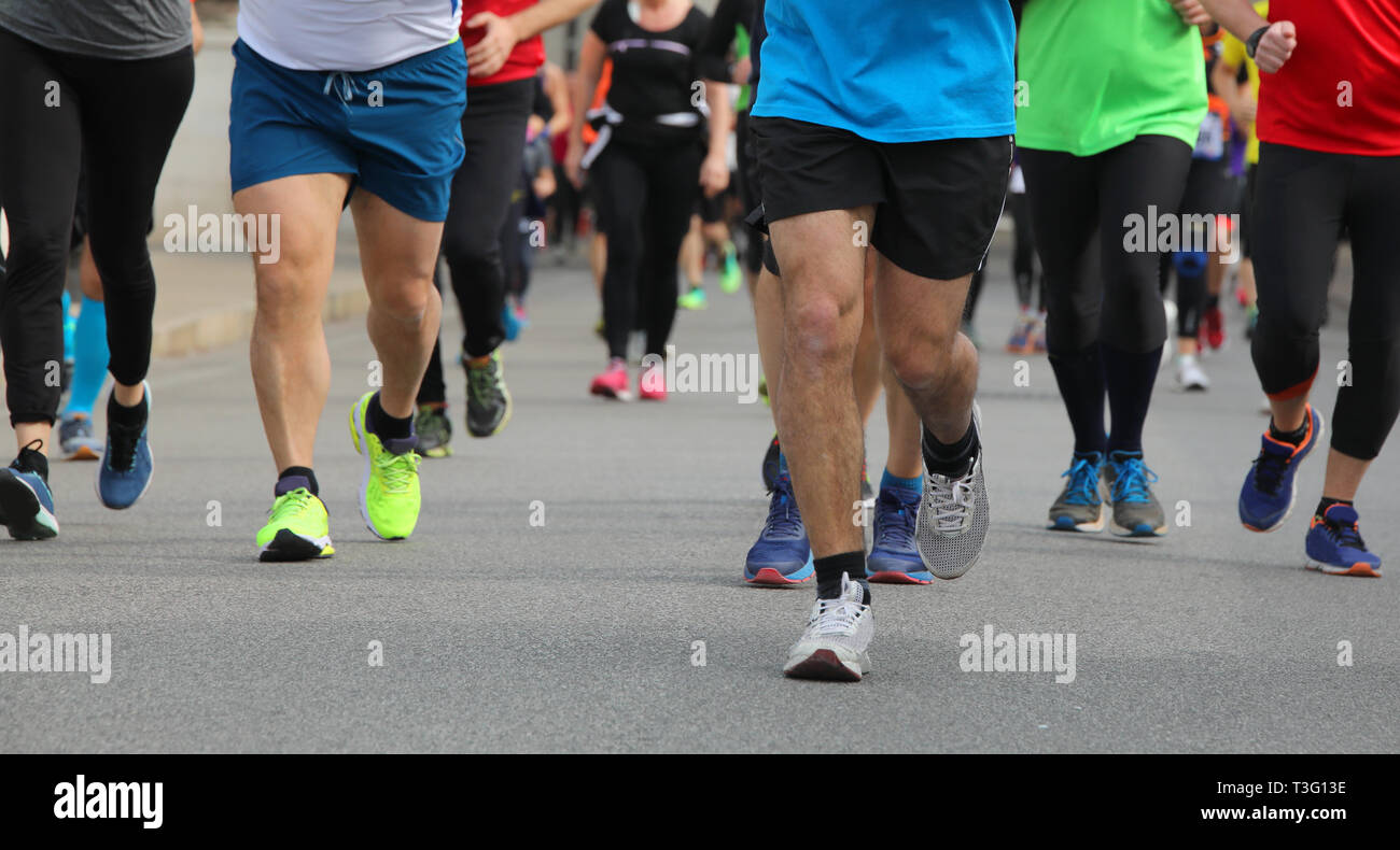 many runner run on the road during a race Stock Photo - Alamy
