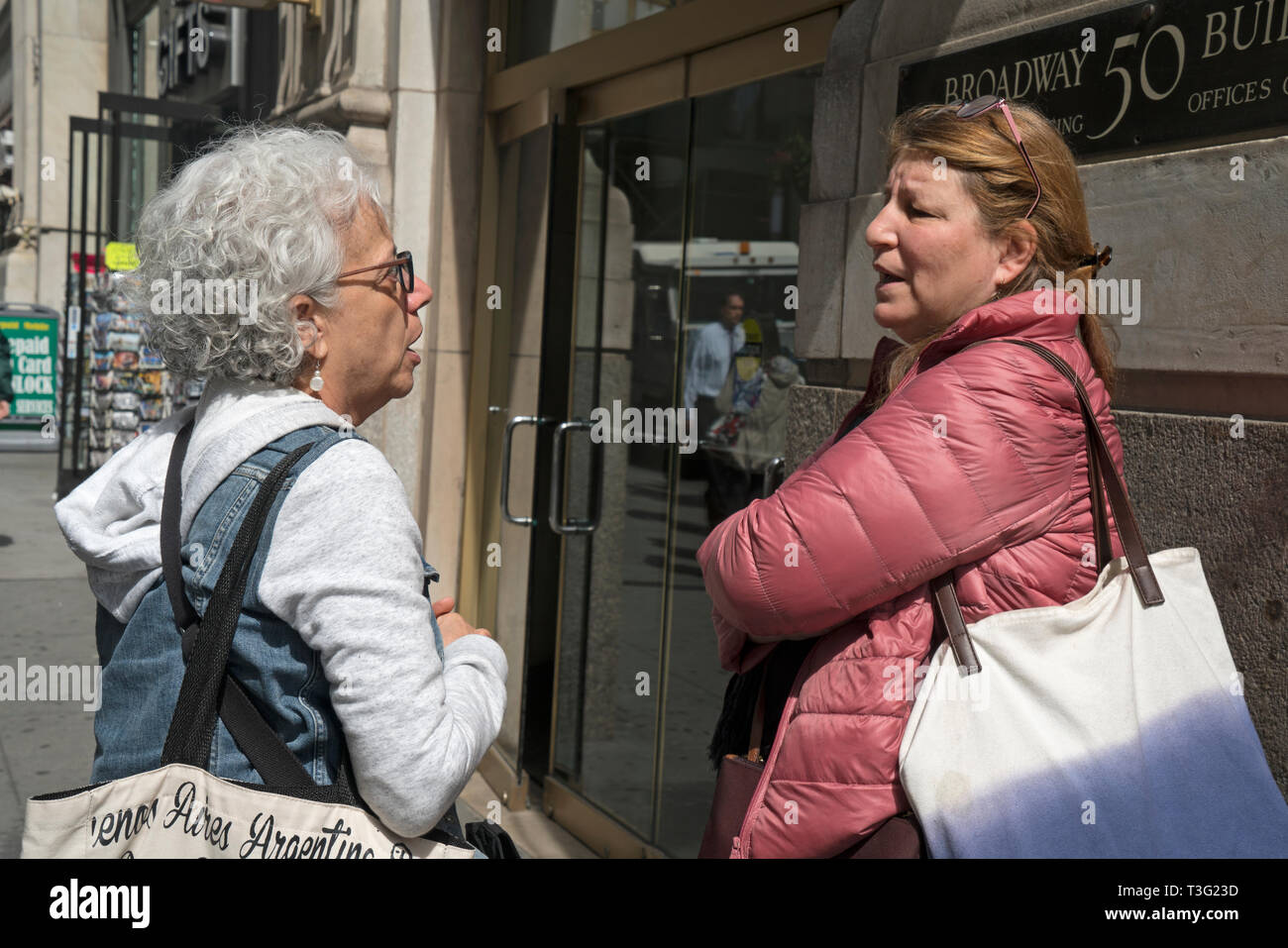 Two women having an earnest conversation on a sunny, spring day on ...