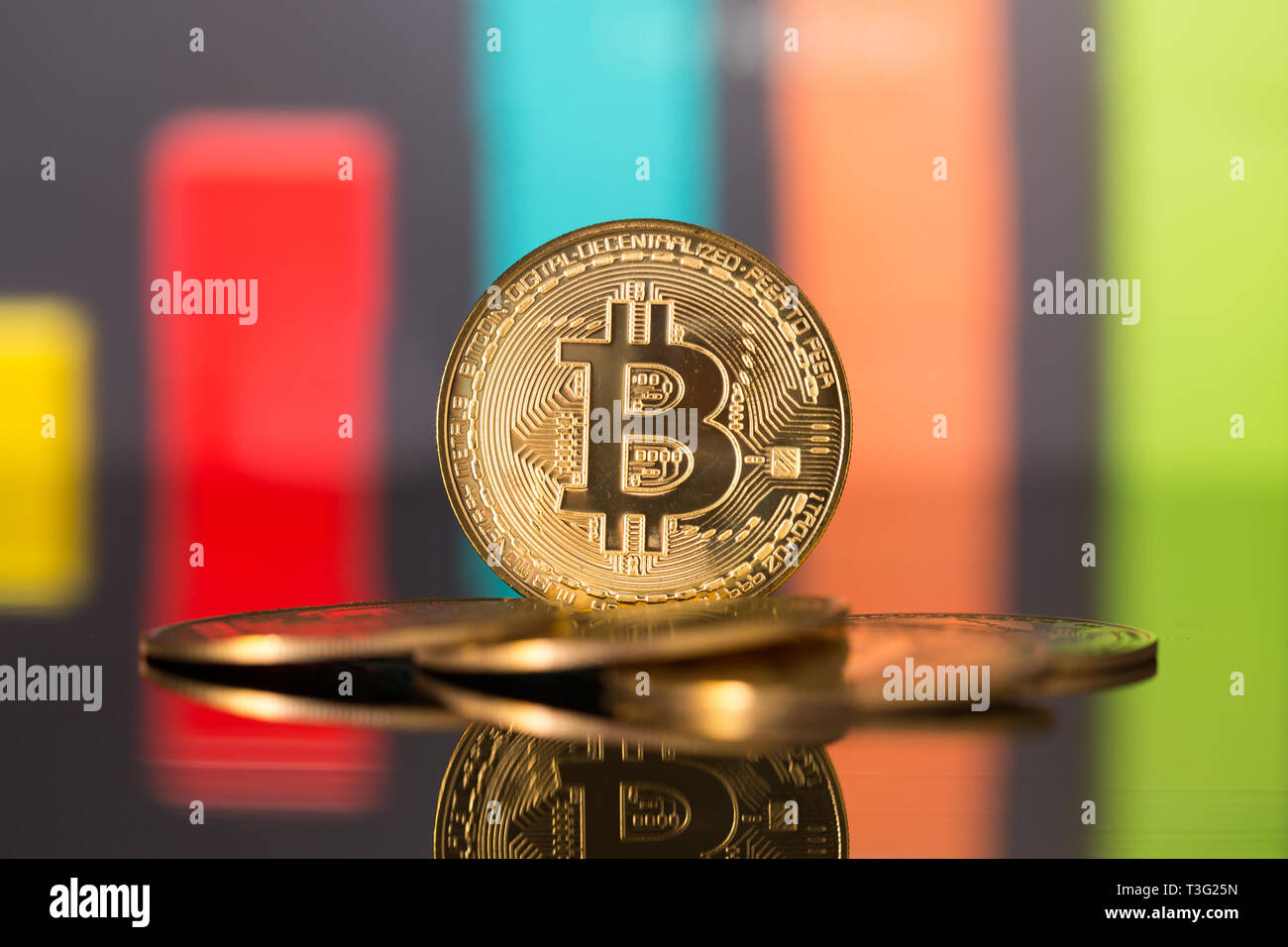 Bitcoin physical coin symbol with graph in the background Stock Photo ...
