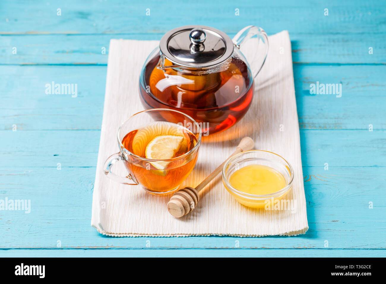 Glass cup of tea with lemon, glass teapot and honey Stock Photo - Alamy