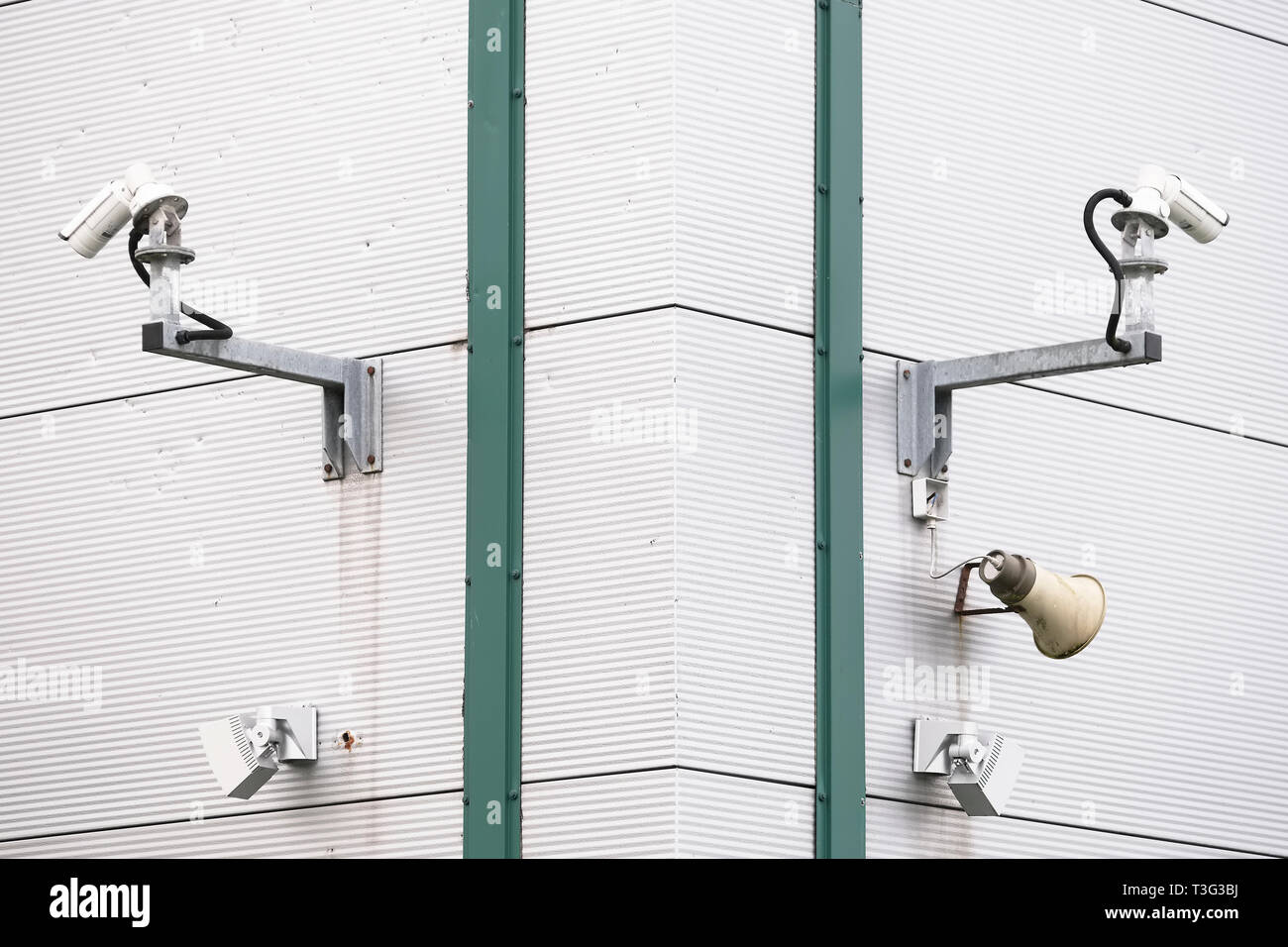CCTV camera in a pair of two on building corner wall Stock Photo - Alamy