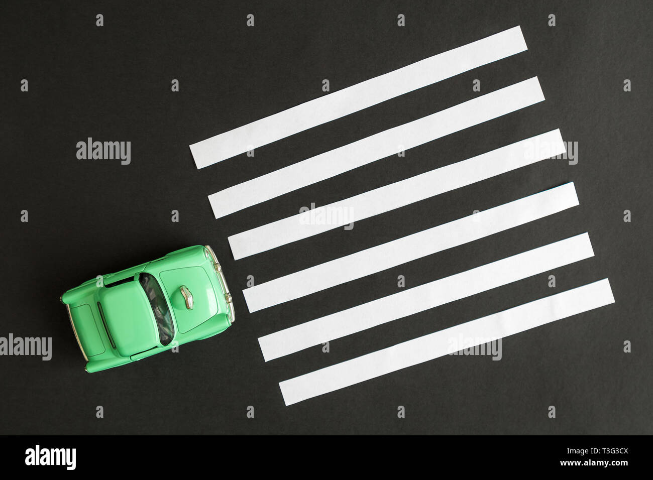 Overhead view of small car and pedestrian pathway on a street crossing ...
