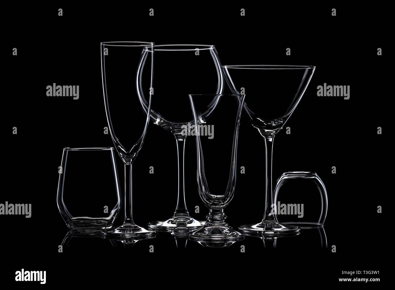 Empty cocktail glassware on a black background Stock Photo - Alamy