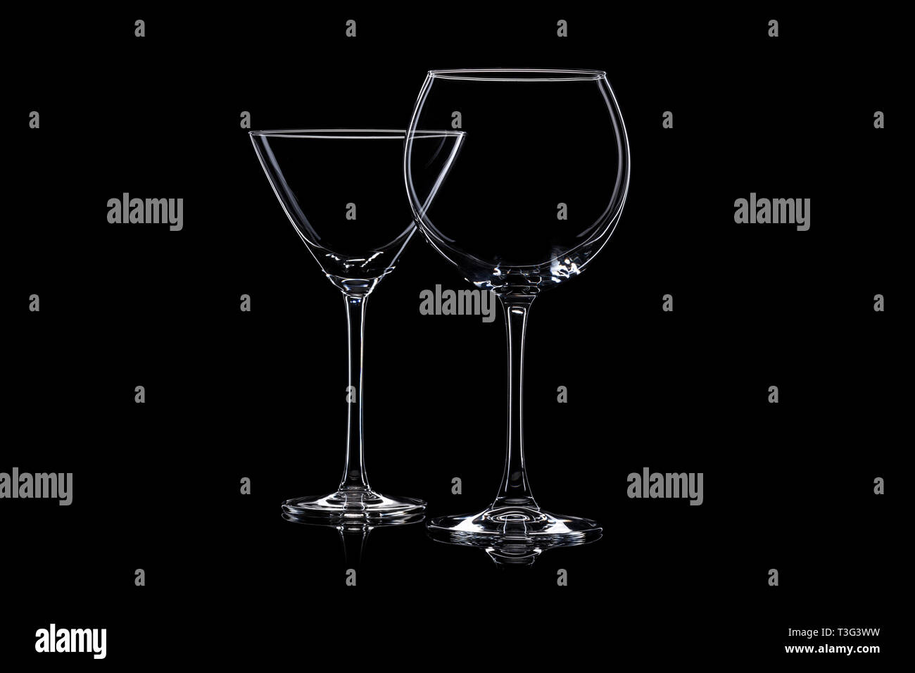 Empty cocktail glassware on a black background Stock Photo - Alamy