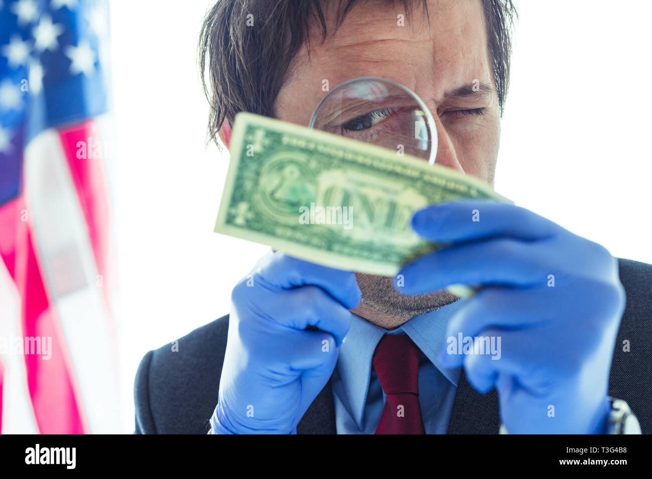 American secret service agent analyzing suspicious counterfeit dollar ...